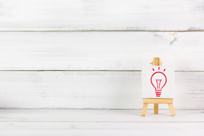 Red Light Bulb Icon on Wooden Easel: Concept of Innovation and Bright ...