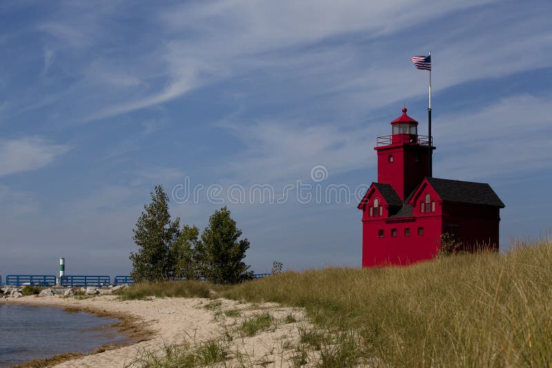 Red lighthouse on beach stock photo. Image of grass, lighthouse - 50575684