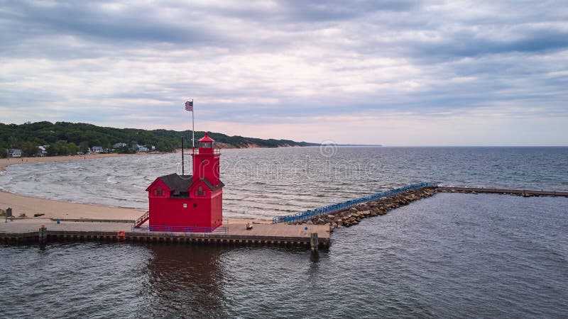 Red Lighthouse on Great Lakes with Waves and Beach Coast Stock Image ...