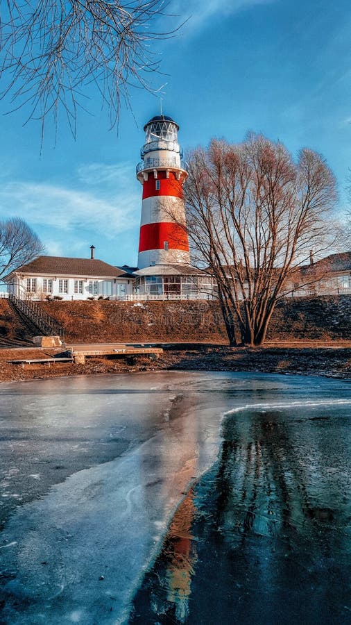 Red lighthouse on the lake stock image. Image of lighthouse - 271943549