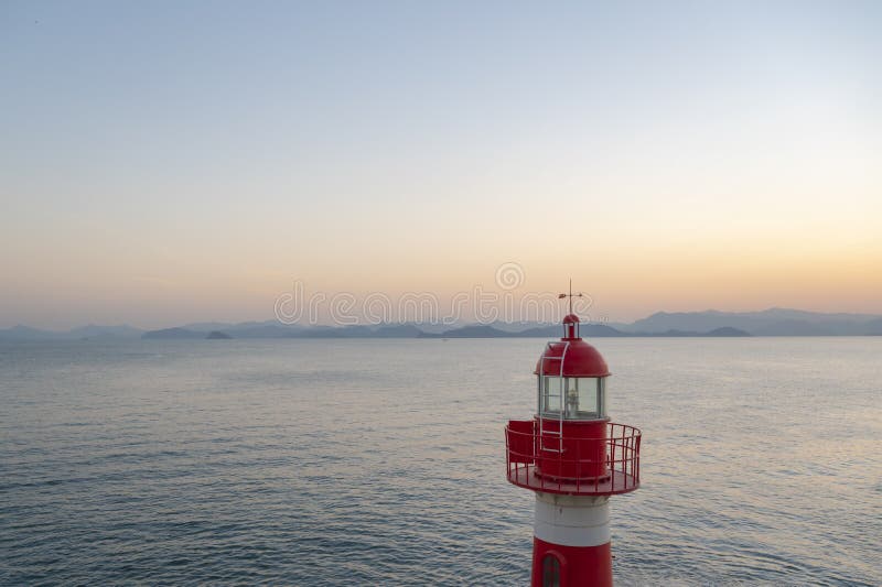 Red lighthouse by the sea stock photo. Image of lighthouse - 206434898