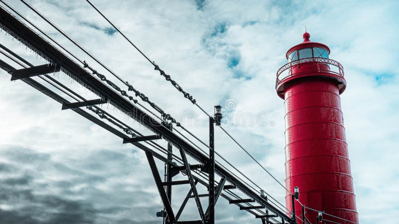 Red Lighthouse Stands beside a Dock in the Middle of a Calm Ocean Stock ...