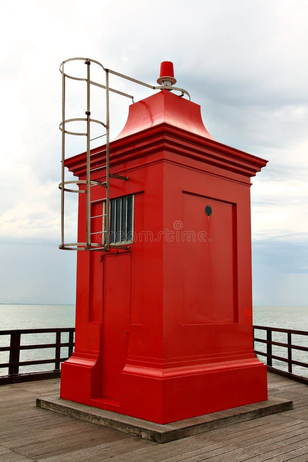 Red Lighthouse on Wooden Jetty Stock Photo - Image of water, lighthouse ...