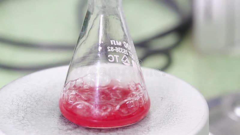 Red Liquid is Bubbling in a Flask Stock Footage - Video of chemistry ...