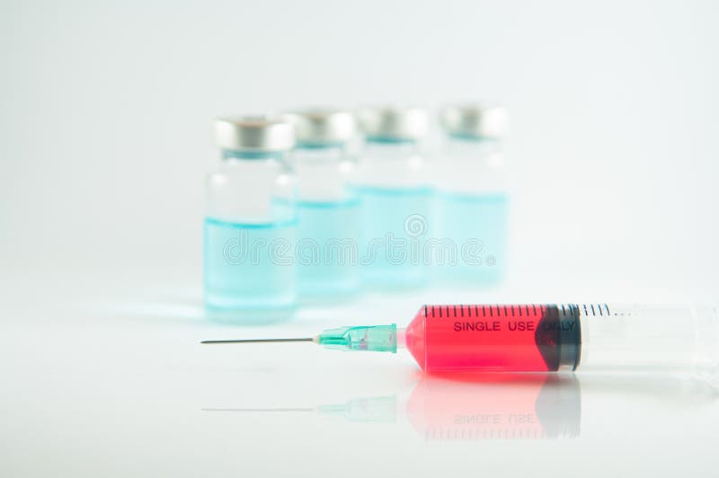 Red Liquid in Injection Syringe and Vials Background Stock Image ...