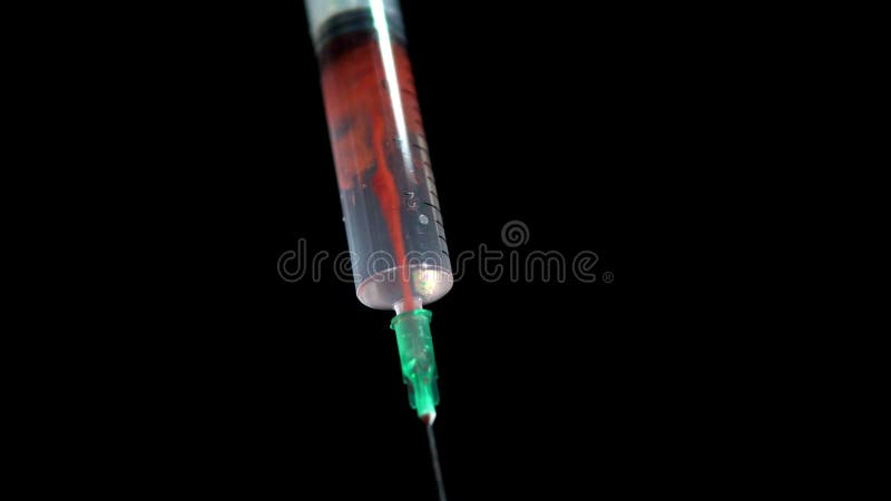 Red Liquid is Mixed in a Syringe with White Liquid on a Black ...