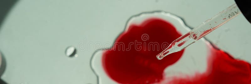 Red Liquid with a Pipette in the Form of a Spot in the Container ...