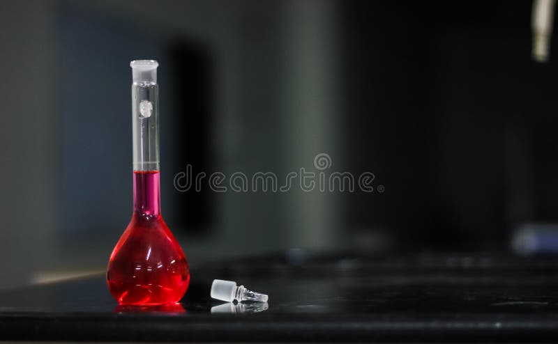 Red Liquid in a Round Bottomed Flask and Glass Beaker and Conical Flask ...