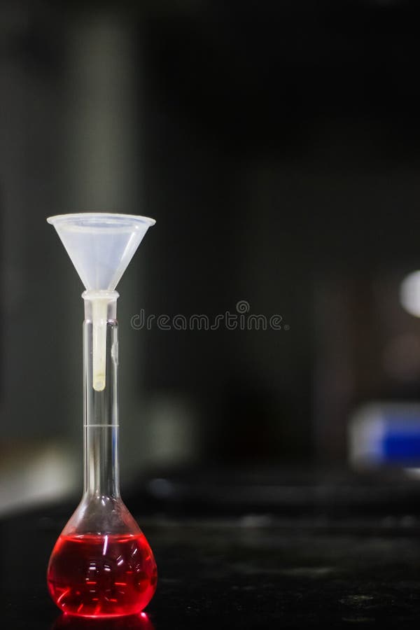 Red Liquid in a Round Bottomed Flask and Glass Beaker and Conical Flask ...