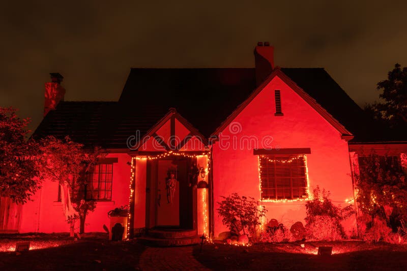 Red Lit Halloween House with Ominous Night Sky Stock Image - Image of ...
