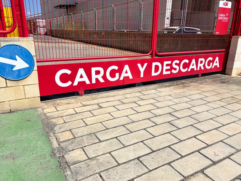 Red Loading and Unloading Gate with Directional Arrow Signage at a ...