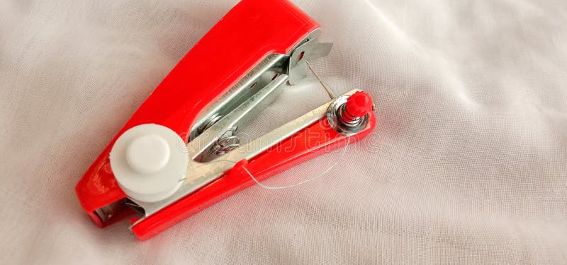 Red Manual Sewing Machine on White Cloth Stock Photo - Image of brand ...