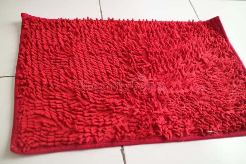 Red mat on the tiled floor stock image. Image of wooden - 257999567