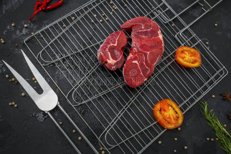 Red Meat on a Grilling Rack with Herbs Surrounding Stock Image - Image ...