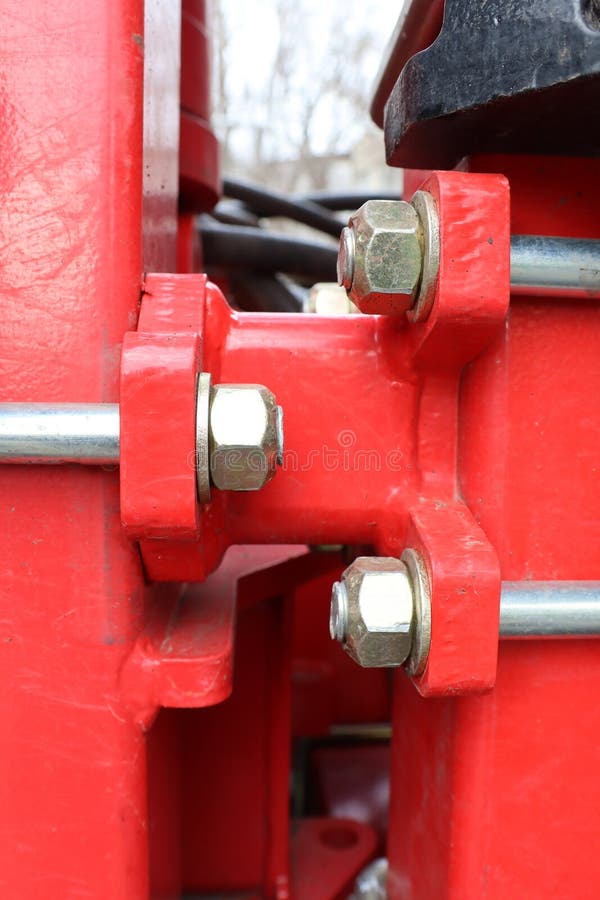 A Red Mechanical Component Consisting of Nuts and Bolts Used in Various ...