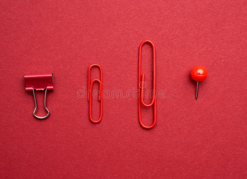 Red Metal Paper Clips, Button on a Red Background Stock Photo - Image ...