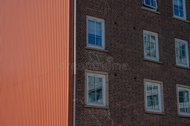 Red Metal Plate Wall by a Brick Building.. Stock Photo - Image of ...
