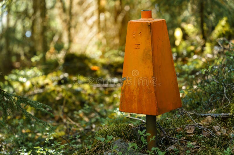 Red Metallic Boundary Marker in a Forest Stock Photo - Image of rural ...