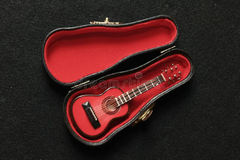 Red Miniature Guitar In Its Case Stock Photo - Image of closeup ...