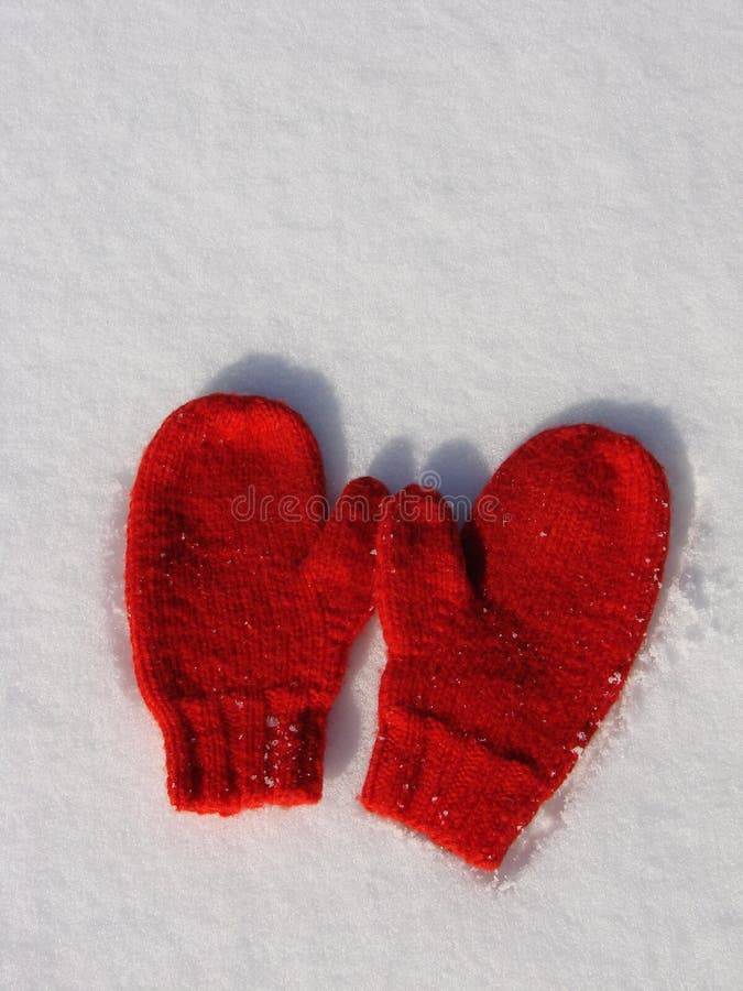 Red mittens on snow stock photo. Image of yarn, sparkle - 12660424