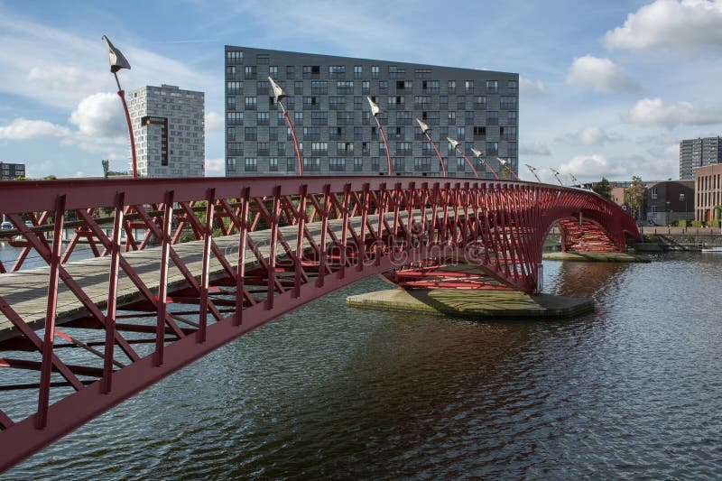 Red Modern Bridge in Amsterdam Near Several Houses Stock Photo - Image ...