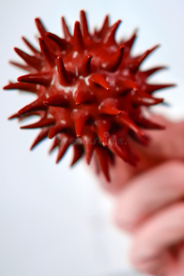 Red Molecule of the Flu Virus in the Hands of a Medic on a White ...