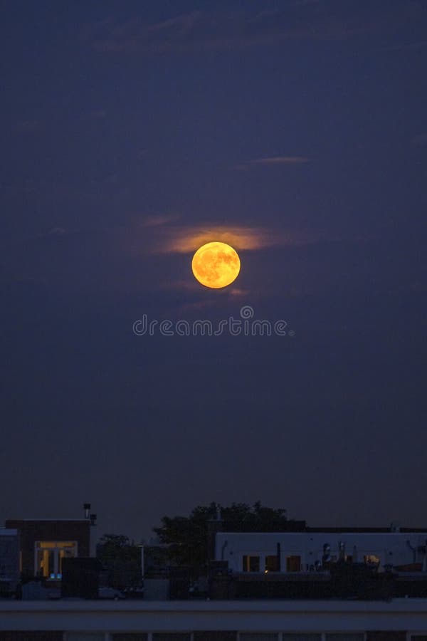 Red Moon Half Hidden by Thick and Compact Clouds at Night Stock Photo ...