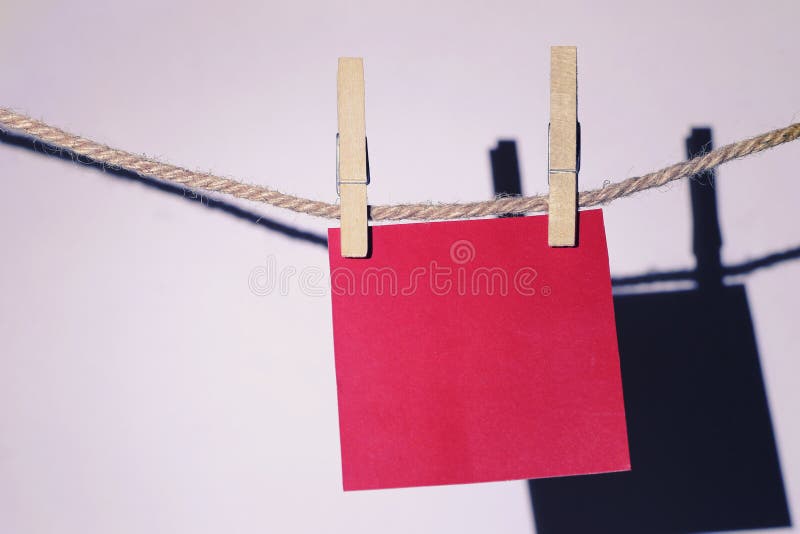 Red Note Paper Hanging on Rope on White Wall Stock Image - Image of ...
