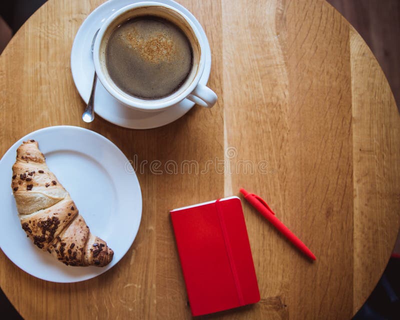 A Red Note and Red Pen is on the Table in a Cafe, a Cup of Coffee and a ...