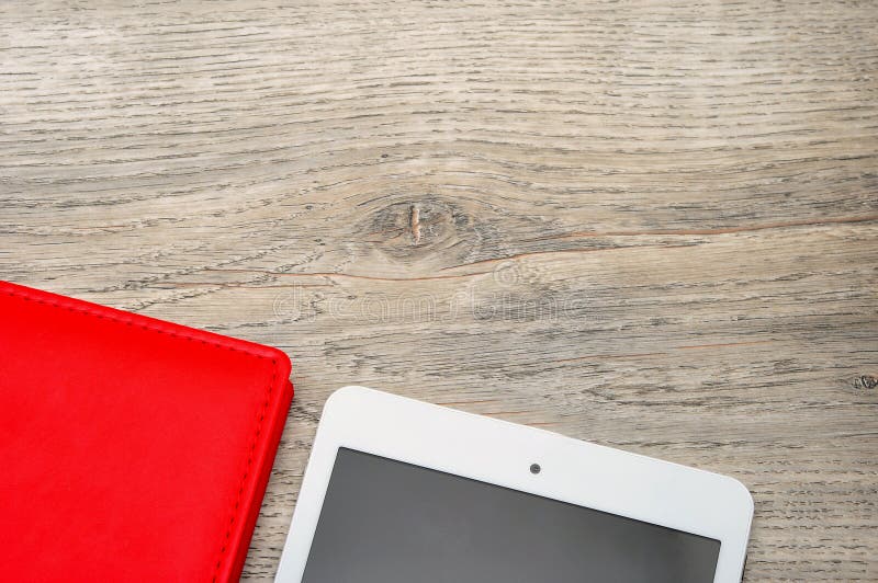 Red Notebook, White Tablet on Table with Wooden Texture. Stock Image ...