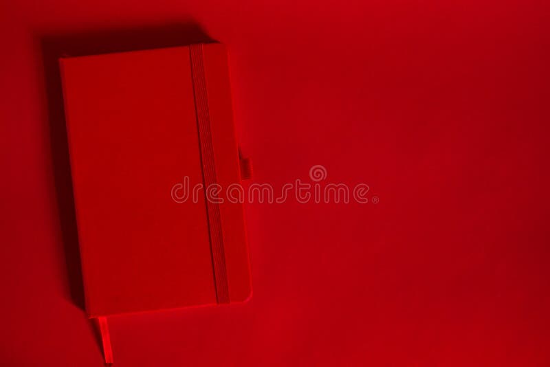 Red Notepad with an Elastic Band on a Red Background. Space for Design ...