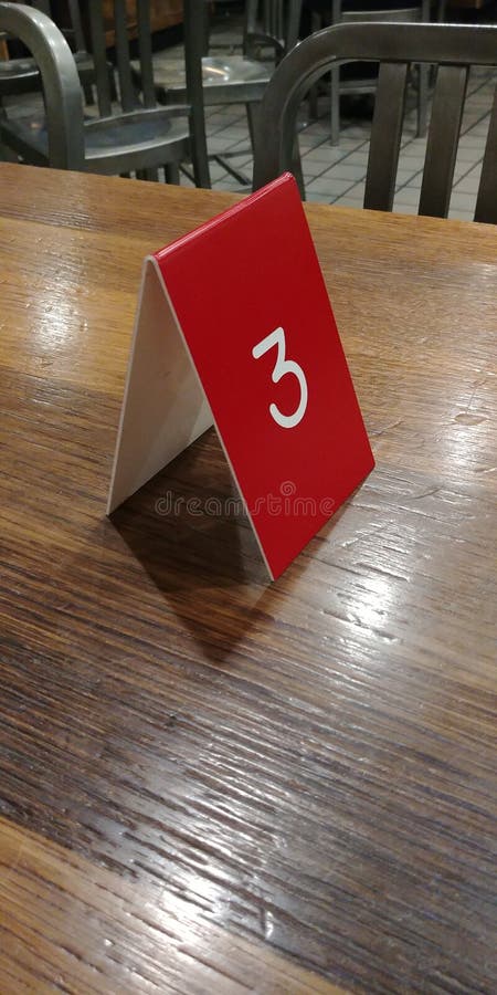 On the Table are a Marker, a Calculator and a Notebook with the ...