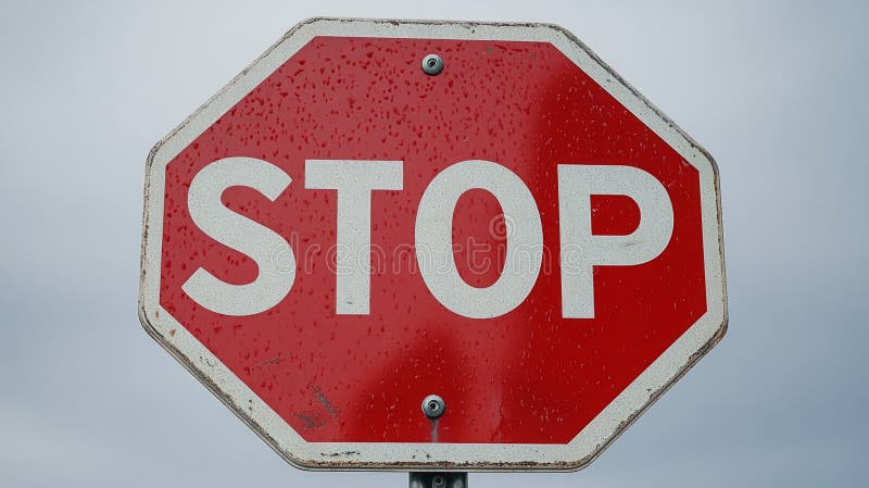 Red Octagonal Stop Sign Against a Cloudy Sky Backdrop. Stock Photo ...