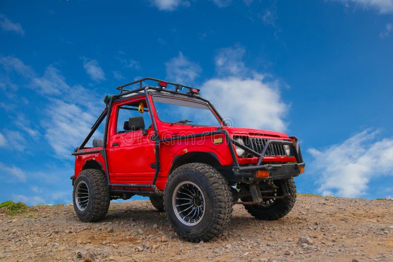 Red Off-road Jeep Car in the Mountains Red Off-road Jeep Car in the ...