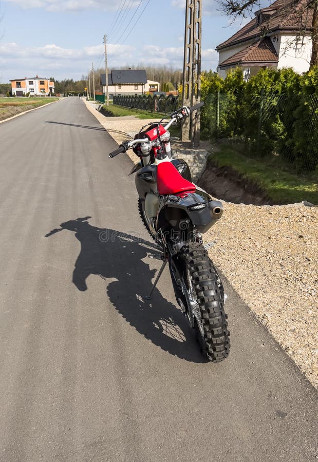 A Red Off-road Motorcycle Set on an Asphalt Road Stock Photo - Image of ...