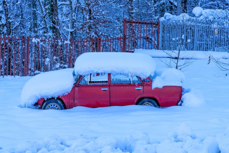 A red old car under snow stock photo. Image of snow - 206673562
