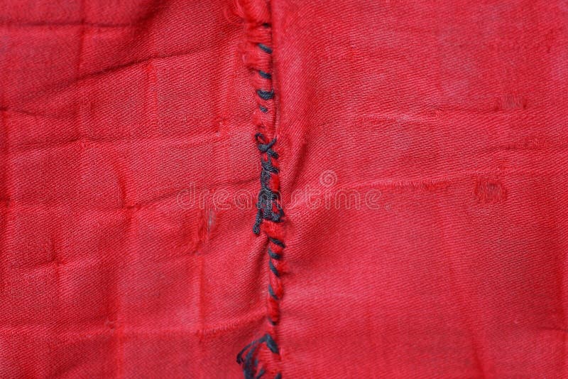 Red Old Ragged Fabric Sewn with Black Thread Stock Image - Image of ...