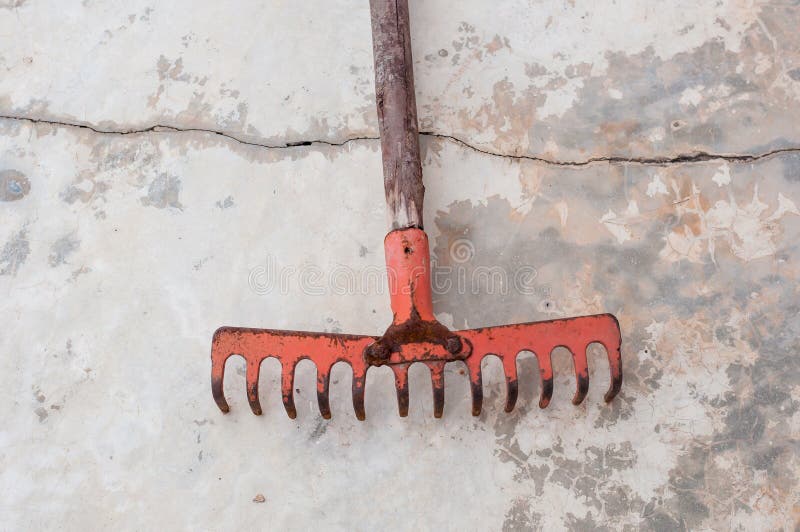 The Red Old Rake on the Break Cement Floor Ground Stock Photo - Image ...