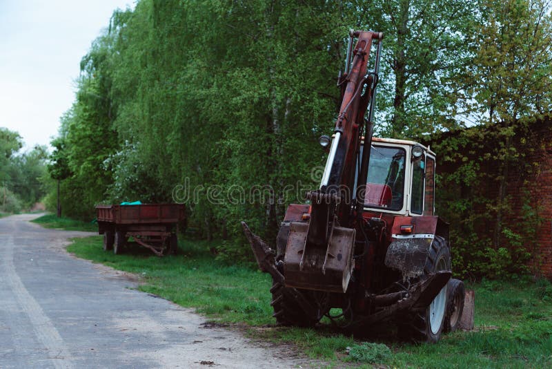 Red Old Rusty Tractor in a Field Near Road Stock Photo - Image of ...
