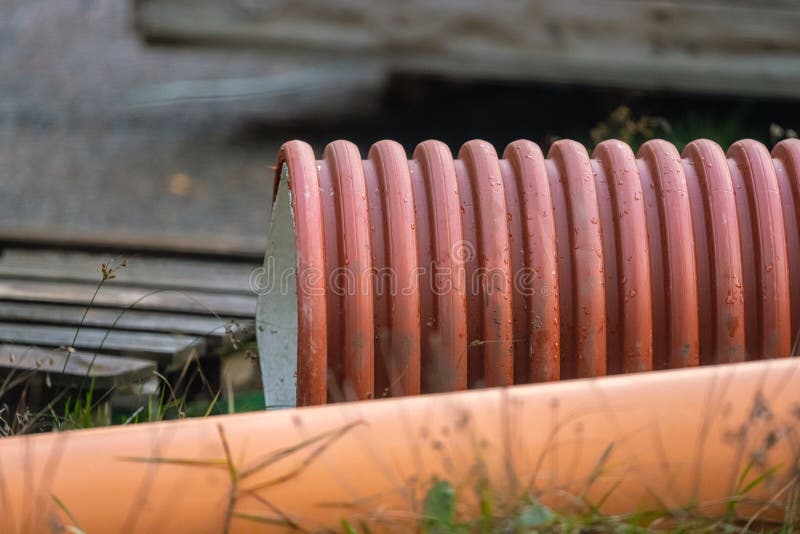 Red and Orange Drain Piped in a Parking Lot.. Stock Photo - Image of ...