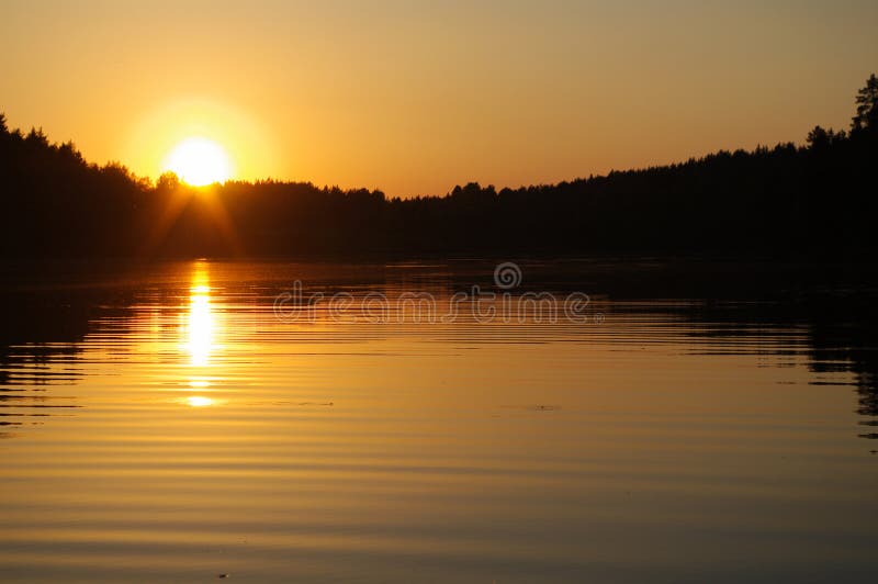Red and Orange Sunset Over Lake with Water Reflection Stock Photo ...