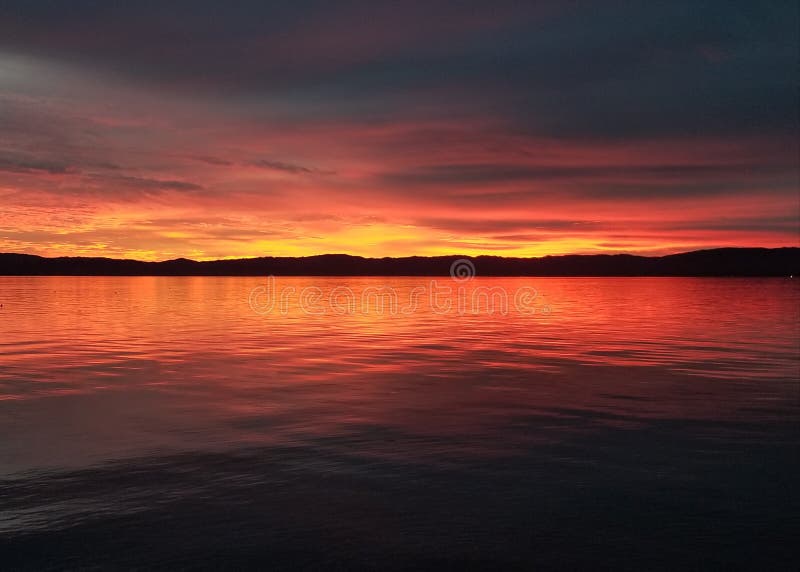 Red orange and water view stock image. Image of dawn - 250720161