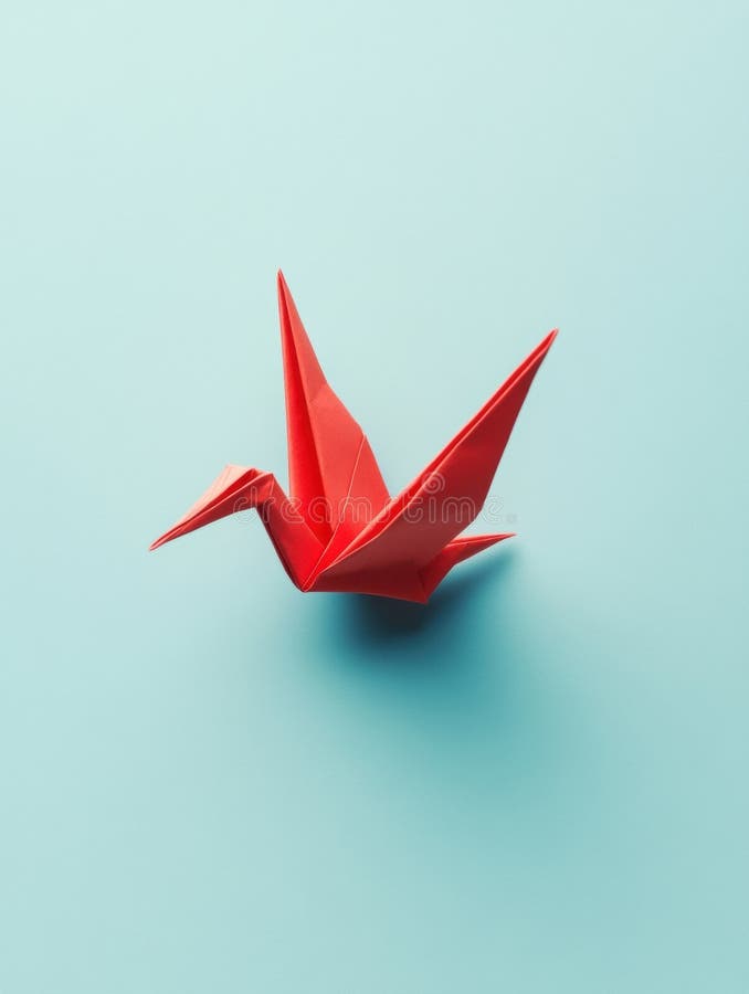 Red Origami Crane on Light Blue Background for Creative Design Projects ...
