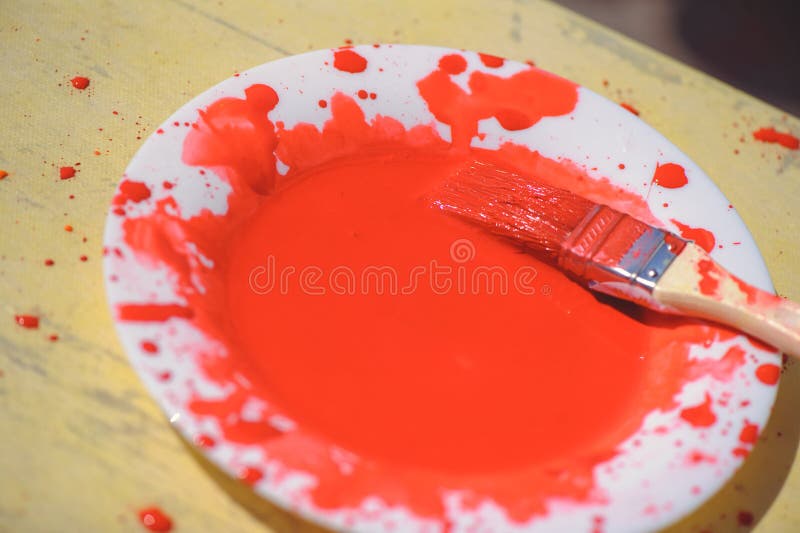 Red Paint in a White Plate with a Brush on the Old Table Stock Image ...