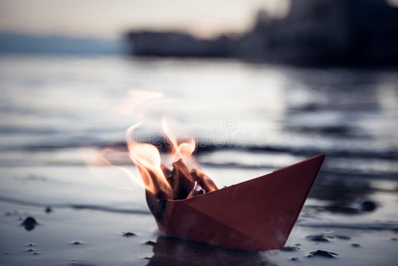 Red paper boat on fire stock photo. Image of business - 97874996