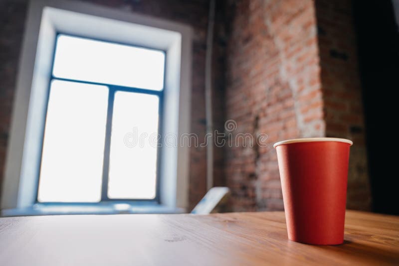 Red Paper Disposable Glass on a Wooden Table on the Background of a ...