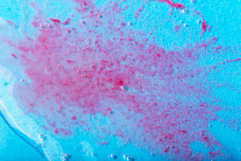 Red Particles in Transparent Liquid on Blue Background Stock Image ...