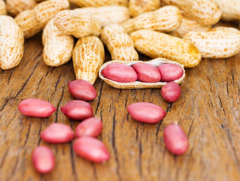 Red peanuts on wood stock image. Image of ingredient - 94775535