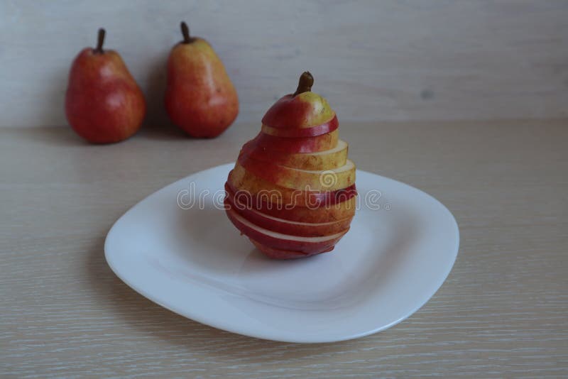 Red Pear Cut into Circles, on a Plate. Stock Photo - Image of food ...