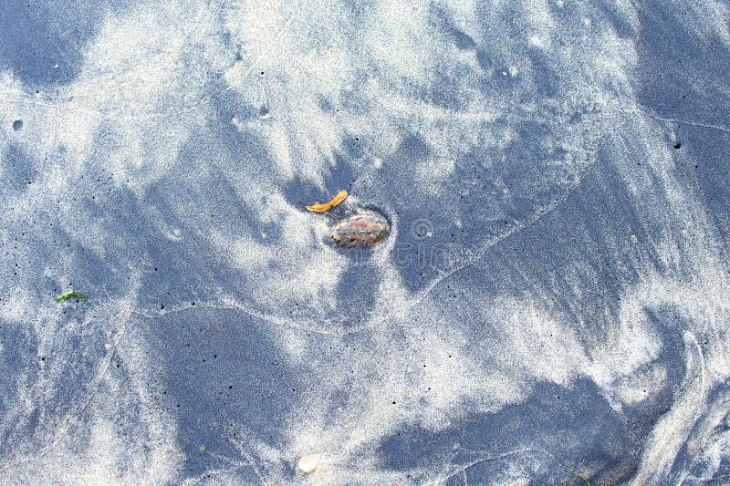 Red Pebble and Orange Leaf in Blue and Beige Sand Stock Image - Image ...